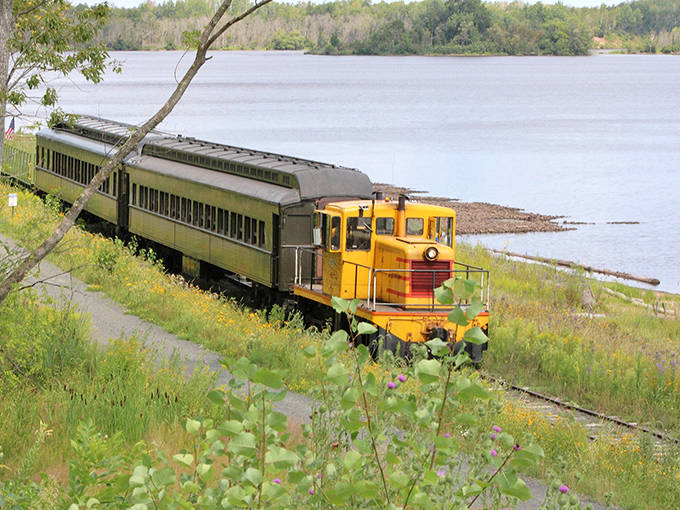 Yellow locomotive power contrasts with the serene blues and greens of the St. Louis River marsh, nature's perfect color palette.