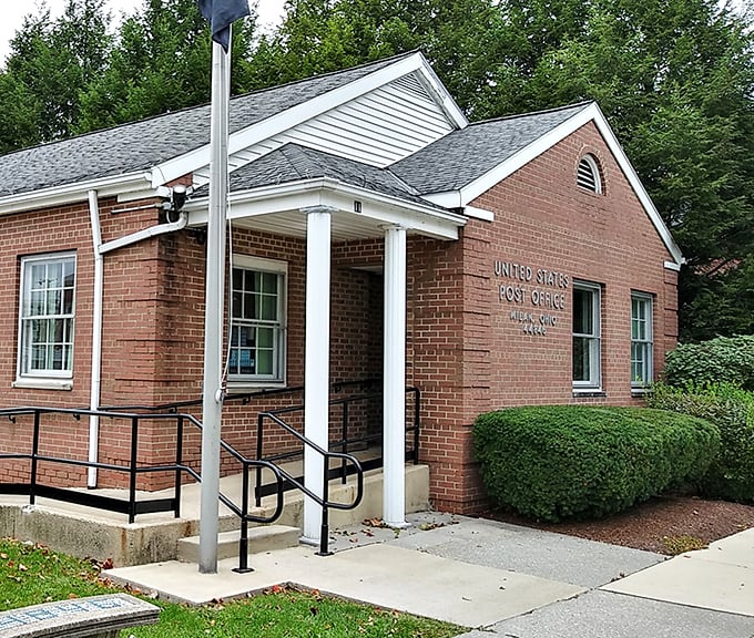 The United States Post Office maintains its brick-and-column dignity, serving the community with architectural grace.