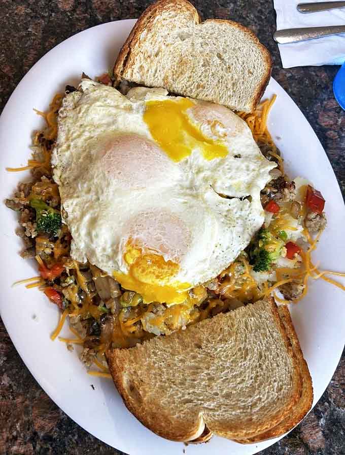 This Veggie Skillet proves healthy eating doesn't mean sacrificing flavor, with eggs crowning a mountain of perfectly seasoned vegetables and potatoes.