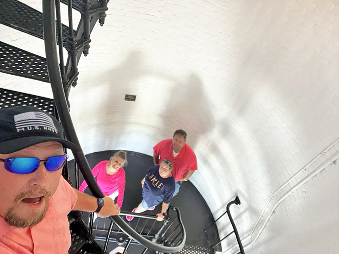 Visitors enjoy the spectacular panoramic view from the observation deck. That smile says "worth every one of those 219 steps!"
