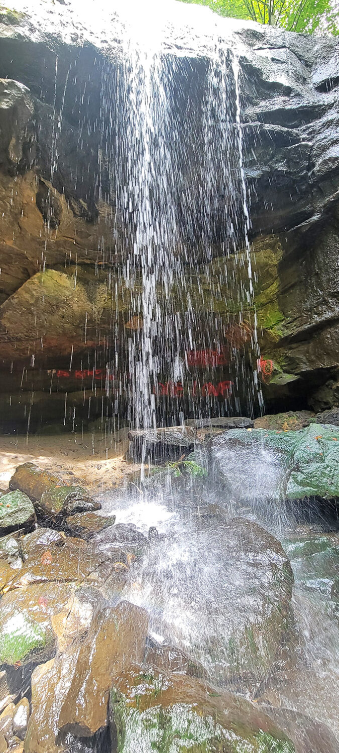 Water creates a crystalline curtain as it plunges into the waiting pool below, hypnotic in its endless rhythm.