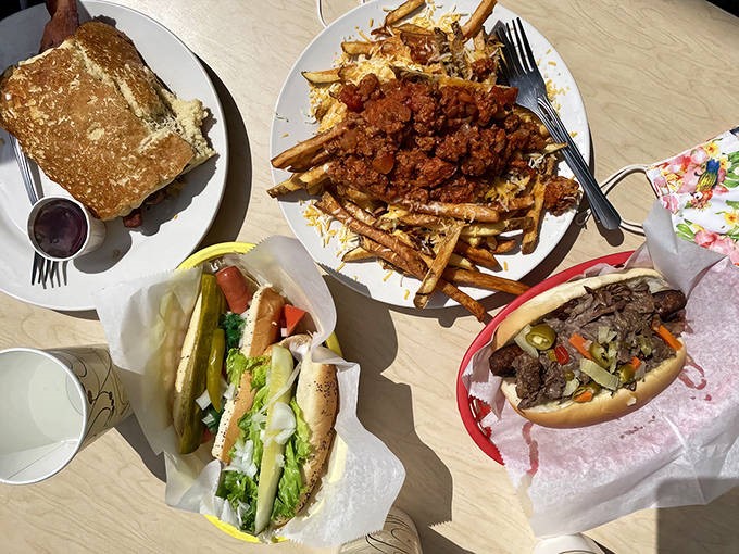 A spread of Wienery classics covers the table &ndash; chili fries, hot dogs, and sandwiches that prove good food doesn't need fancy presentation.