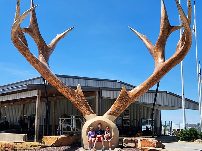 These massive antlers create the perfect photo opportunity. Three children demonstrate the scale of this enormous rack that would make any hunter do a double-take.