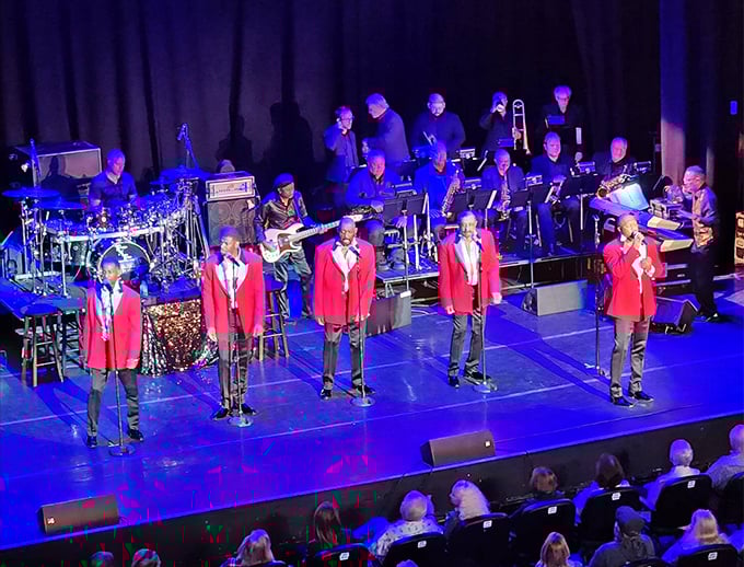Performers in crisp red jackets deliver big band classics, their brass section shining as brightly as the smiles in the audience.