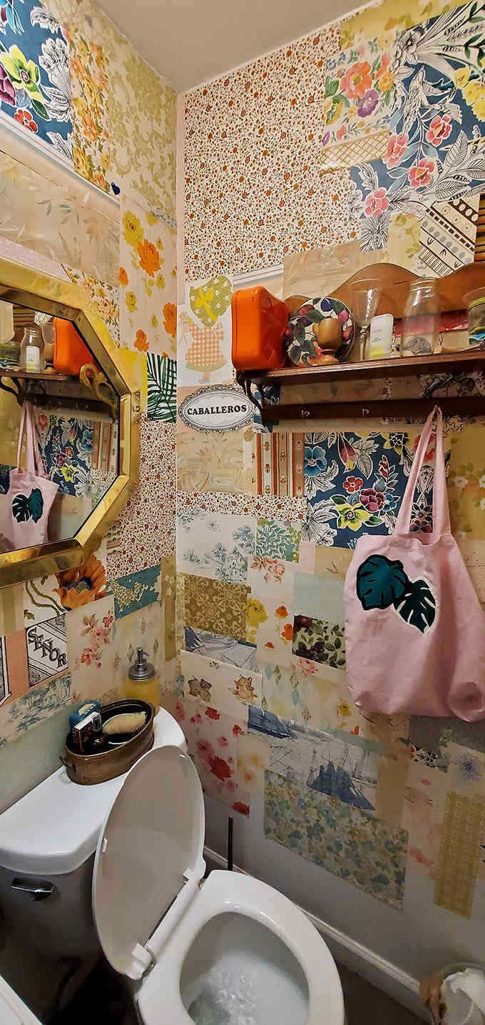 Tiny bathroom, big personality at The Little Light Collective, where patchwork walls turn a quick stop into joyful surprise inside.