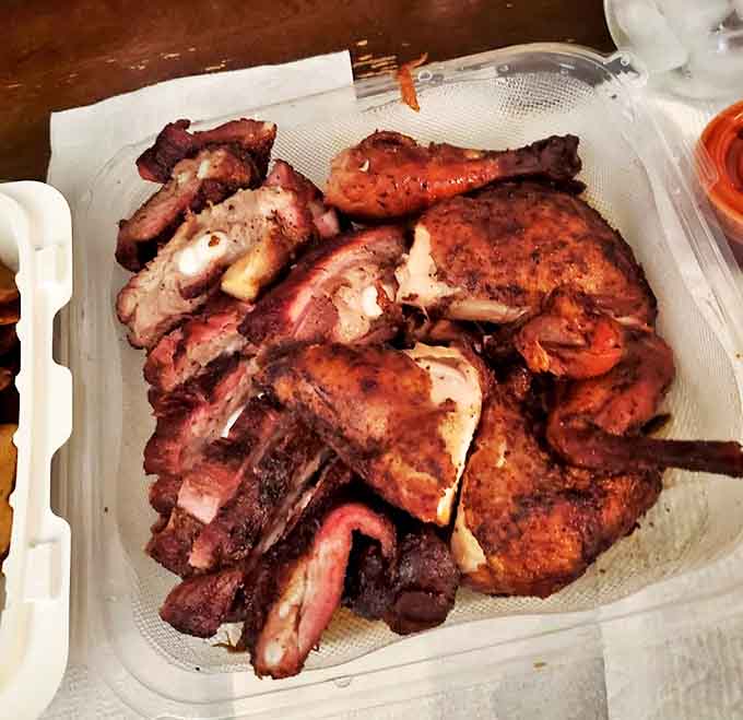 The combination plate showcases barbecue versatility &ndash; perfectly smoked chicken alongside succulent ribs, each with its own distinct character but united by smoke.