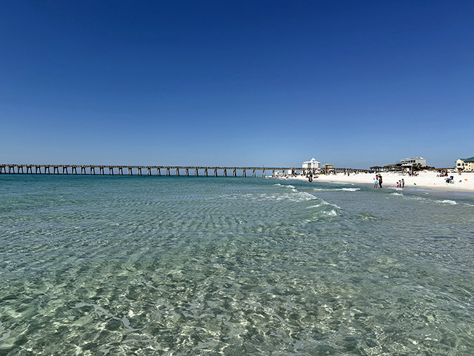 The fishing pier stretches toward the horizon like a runway for dreams, connecting land-dwellers to the mysteries of the deep.