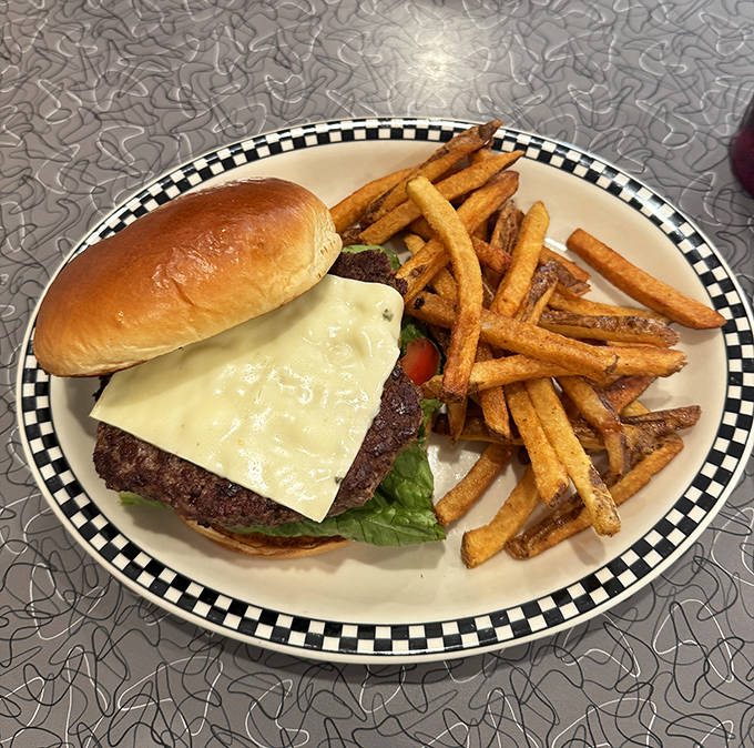 The classic cheeseburger and fries combo – where hand-formed patties meet golden fries in a dance as old as American dining itself.