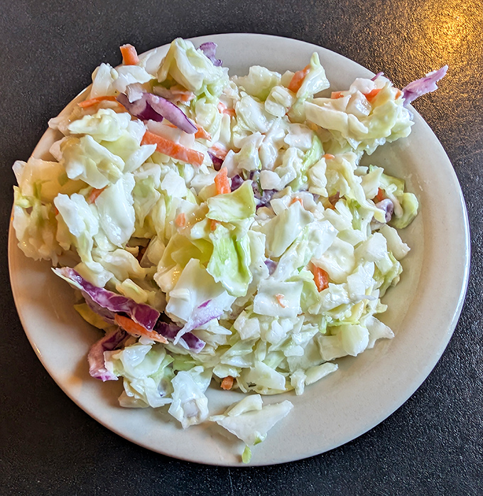 The humble coleslaw provides the perfect crisp, cool counterpoint to the richness of the smokehouse specialties.