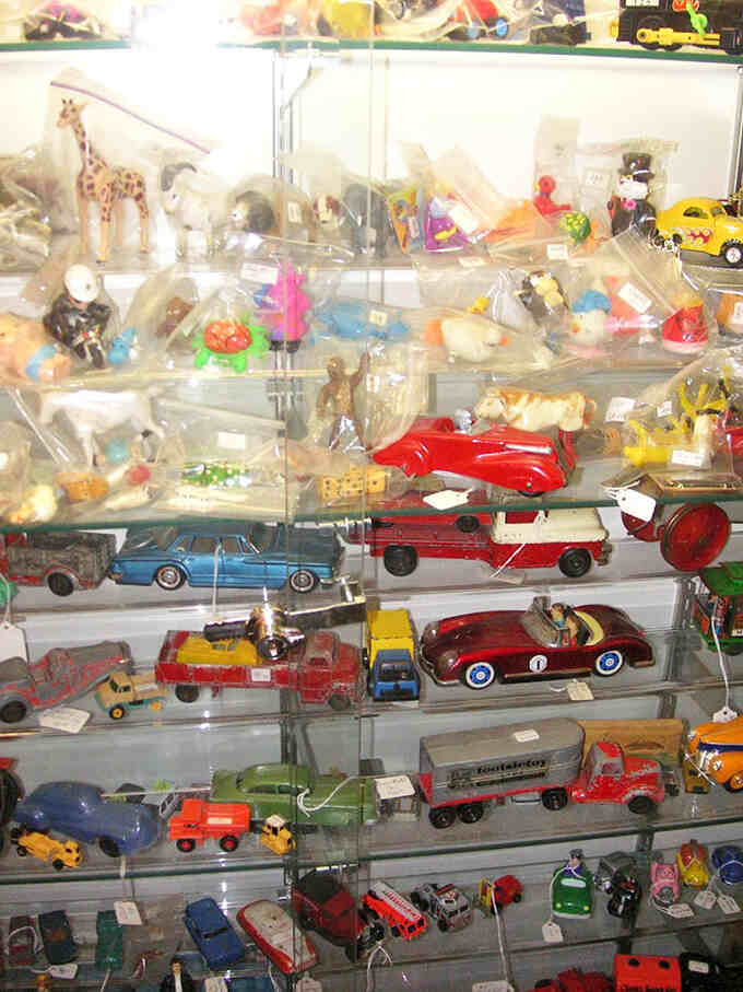 Vintage toys and collectibles arranged with curatorial precision. Remember when imagination was the only special effect needed for afternoon adventures?