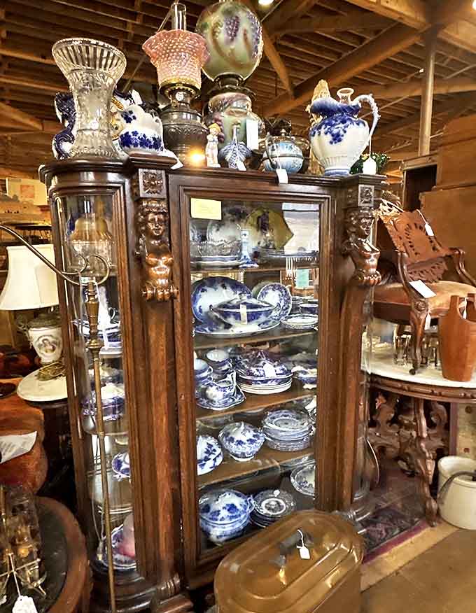 This magnificent wooden cabinet showcases fine china and porcelain with the reverence these heirlooms deserve &ndash; each piece telling stories of formal dinners past.