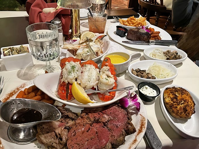 A feast fit for royalty &ndash; prime rib, lobster tail, and all the accompaniments spread across the table in a display of supper club abundance.