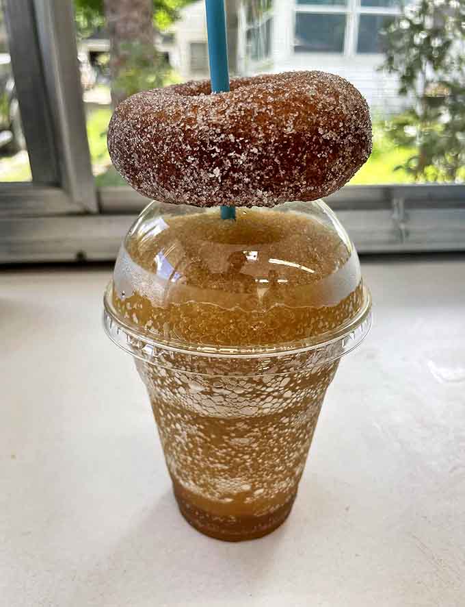The ultimate pairing: A warm, sugar-dusted donut playing king of the mountain atop a frosty apple cider slushie.