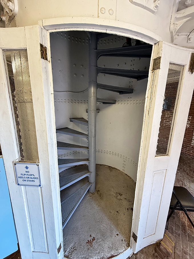 The spiral staircase beckons visitors upward, its white metal steps promising panoramic rewards for those willing to make the climb.