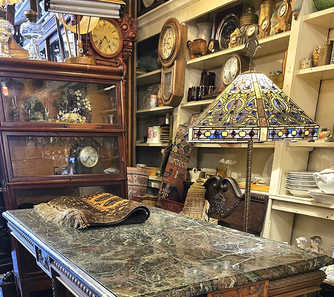 Tiffany-style lamps cast kaleidoscope shadows across marble tabletops, creating the perfect spot to display treasures you didn't know you needed.