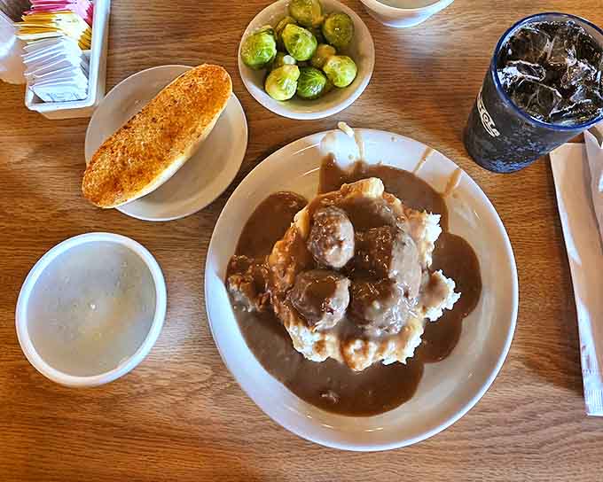 Meatballs swimming in rich gravy alongside mashed potatoes, because sometimes you need a break from beef to enjoy some... well, more beef in ball form.