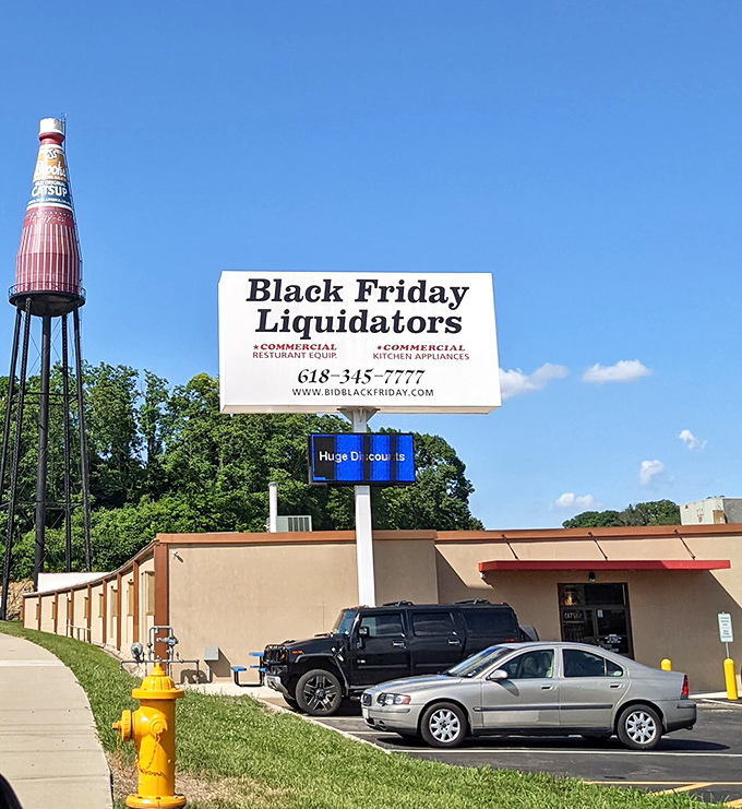 Even the fire hydrant is yellow! The iconic red catsup bottle stands tall against the blue sky near local businesses.