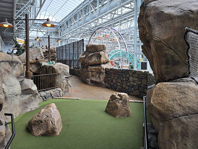 Winding stone pathways guide golfers through cavernous passages &ndash; "No Running" signs suggest previous visitors learned this lesson the hard way.