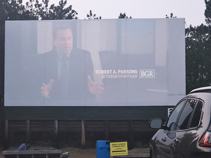 The screen comes alive with content, transforming the forest clearing into an immersive entertainment experience.