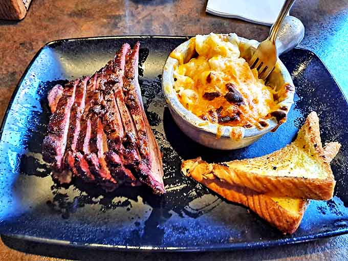 Brisket sliced to perfection alongside mac and cheese &ndash; a pairing so right it makes you wonder why anyone eats anything else.
