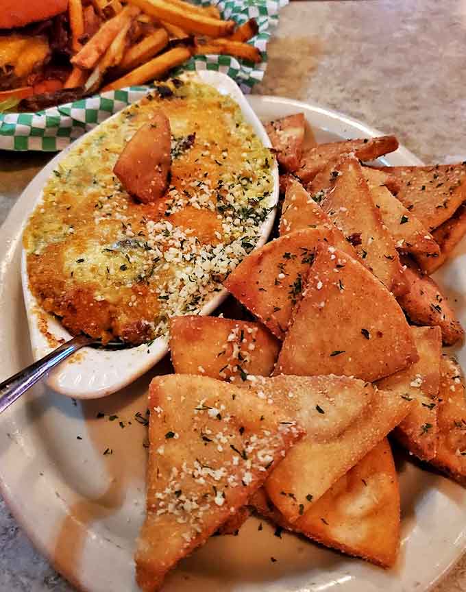The spinach artichoke dip arrives bubbling hot with perfectly toasted pita triangles &ndash; comfort food that somehow feels sophisticated.