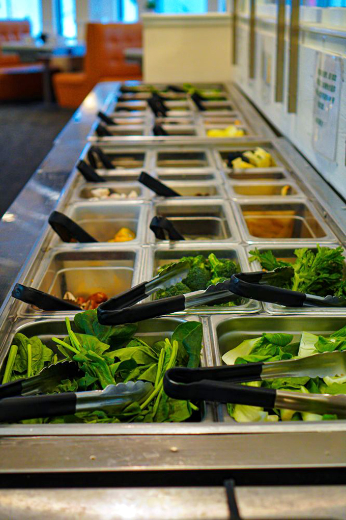 Garden-fresh vegetables await their hot broth bath. From leafy greens to crunchy stems, these vibrant veggies are the unsung heroes of hotpot dining.