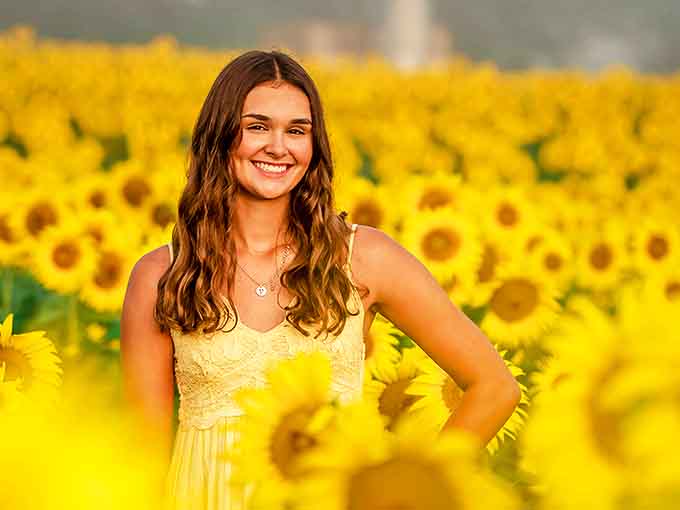 Golden petals frame a visitor's summer joy &ndash; these fields have a way of making everyone look like they belong in a lifestyle magazine.