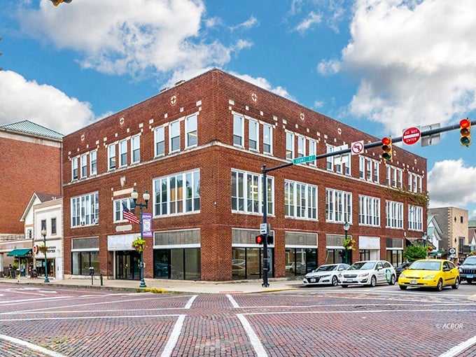 The corner building in Athens stands as a perfect example of preserved historic architecture, where modern businesses thrive in century-old spaces.