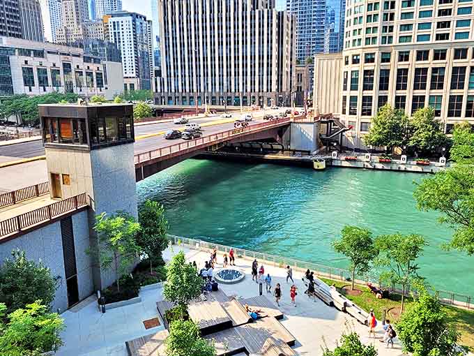 A peaceful riverside plaza offers respite from urban hustle, where office workers and tourists alike can dangle their feet above the flowing water below.
