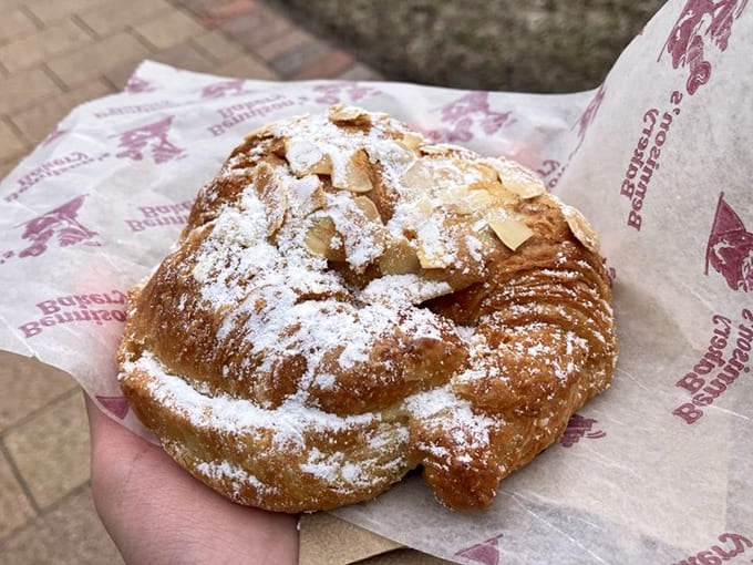 This almond croissant isn't just breakfast&mdash;it's a buttery, flaky work of art dusted with powdered sugar like the first perfect snowfall.