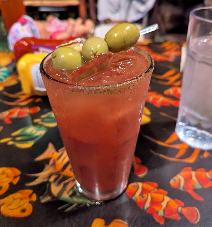 The Bloody Mary comes garnished with olives standing at attention, a crimson concoction that's part drink, part appetizer, all adventure.