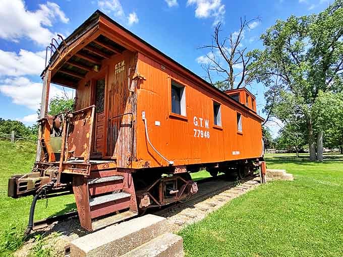 The bright orange caboose stands as a colorful reminder that Michigan's communities were built on railroad connections, not internet ones.