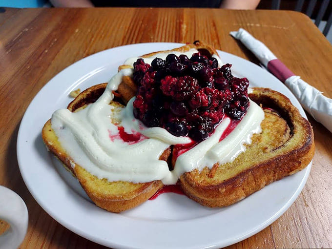 French toast that thinks it's dessert, crowned with berries and cream. Breakfast or midday treat? Why not both?