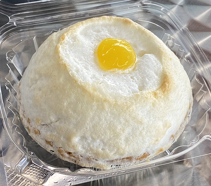 The cloud egg pastry defies gravity and expectations &ndash; a fluffy meringue dome with sunny yolk center that's part optical illusion, part breakfast-inspired dessert genius.
