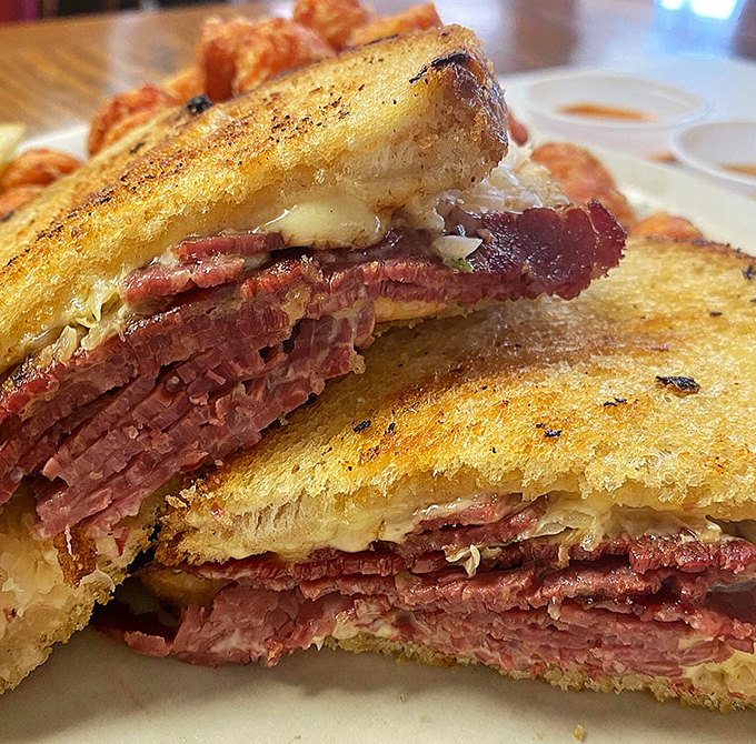 The Reuben sandwich &ndash; a towering monument to corned beef that requires both hands, several napkins, and absolutely no regrets.