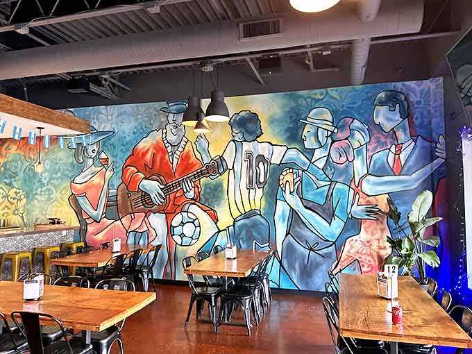 The vibrant mural transforms dining into an experience, depicting musicians and soccer players in a colorful celebration of Argentine culture.