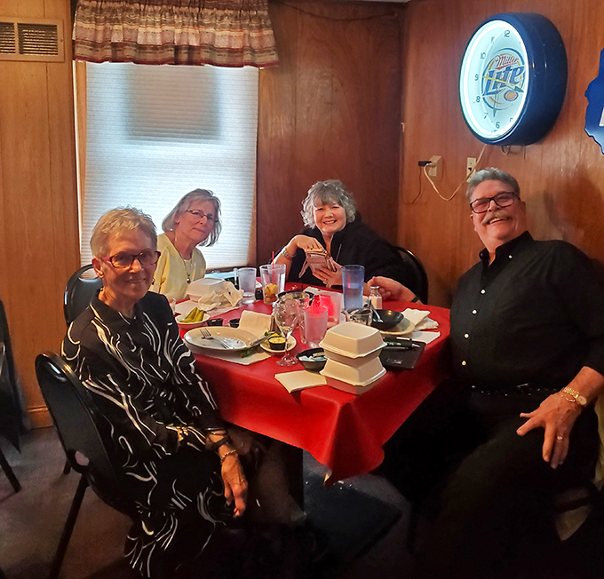 Happy diners gathered around red-clothed tables, creating memories over meals that transcend mere sustenance.