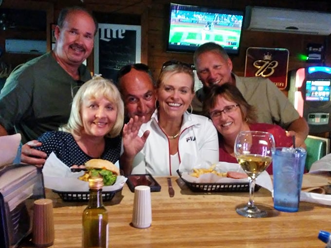 Happy diners sharing the Top Dawg's experience &ndash; where strangers become friends over shared burger appreciation.