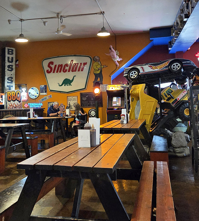 Vintage Sinclair dinosaur signage watches over diners as they embark on prehistoric-sized portions of smoky, tender barbecue goodness.