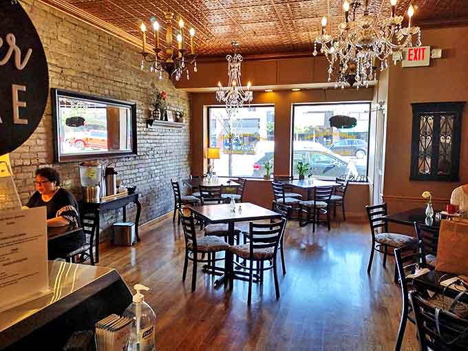 The dining area balances rustic charm with understated elegance, where wooden tables and brick walls create the perfect backdrop for dessert drama.