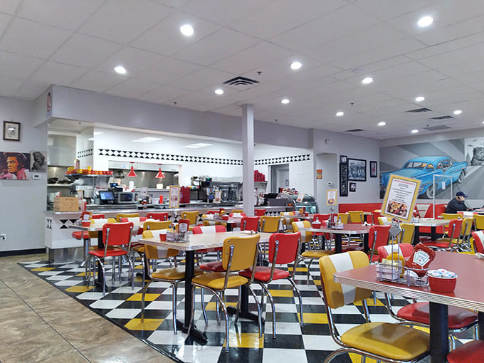 The dining area's retro charm creates a warm, welcoming atmosphere where vintage car murals transport you to simpler times.