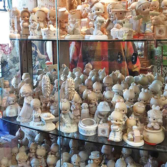 An army of Precious Moments figurines stands in formation, their wide-eyed innocence either heartwarming or slightly unnerving, depending on your perspective.