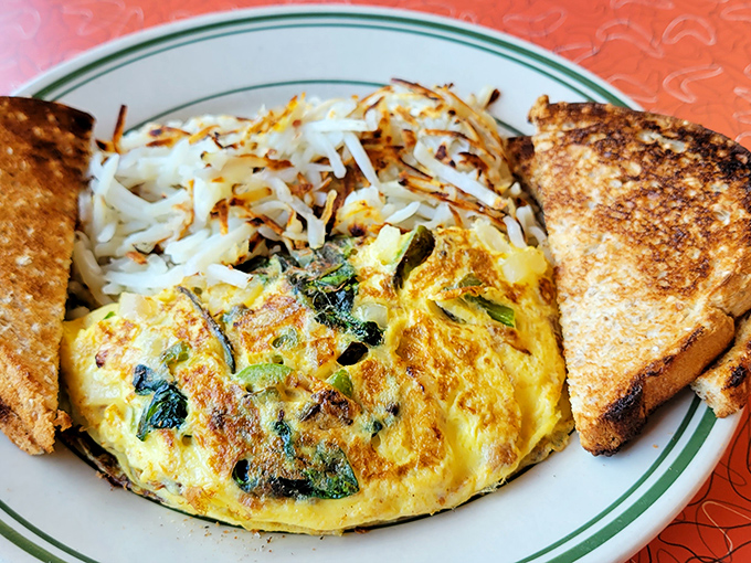This isn't just any omelet &ndash; it's a masterclass in breakfast engineering, with perfectly distributed fillings and hash browns crisped to golden perfection.
