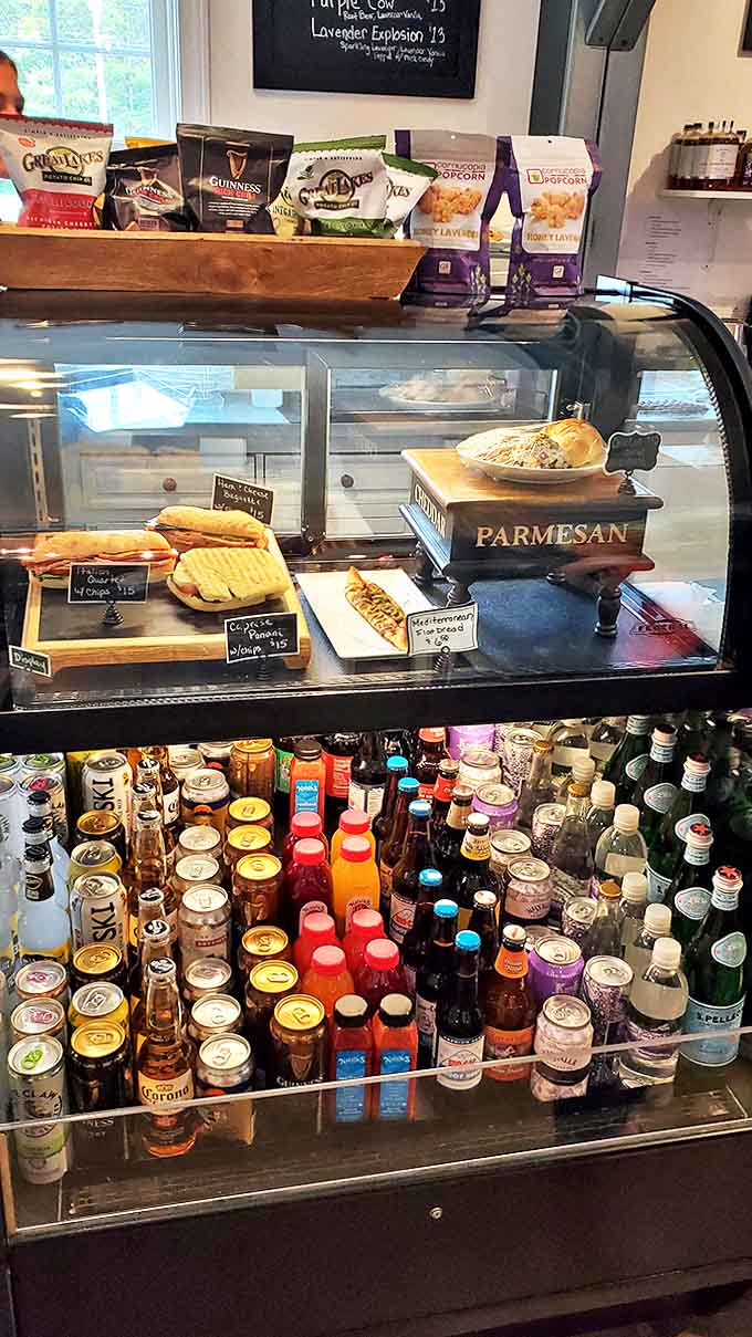 A refrigerator rainbow of refreshments stands ready to quench thirsts worked up from wandering through fragrant fields.