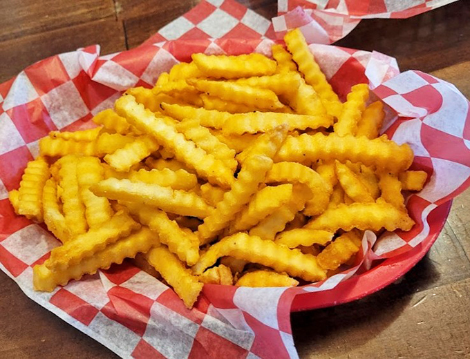 Crinkle-cut fries that achieve the impossible &ndash; crispy exteriors giving way to fluffy potato perfection with each golden bite.