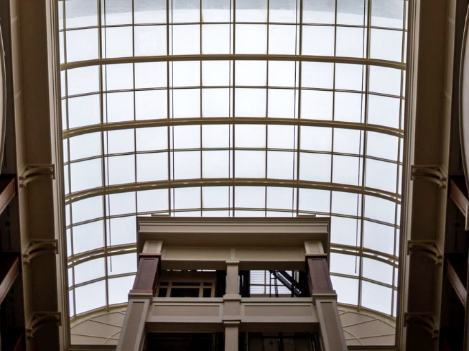 The soaring glass ceiling floods the interior with natural light. It's like working inside a greenhouse&mdash;if that greenhouse were inside a giant basket.