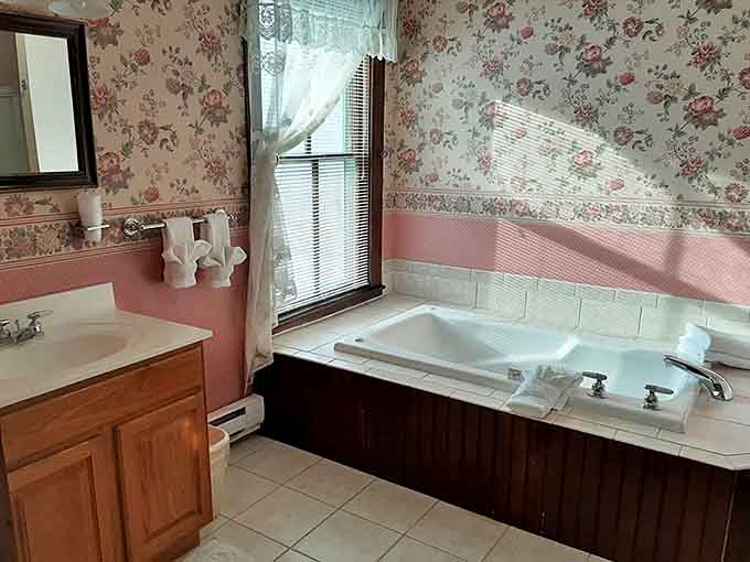 Even the bathrooms tell a story of nostalgic charm, where floral wallpaper and modern fixtures create an unexpectedly perfect harmony.