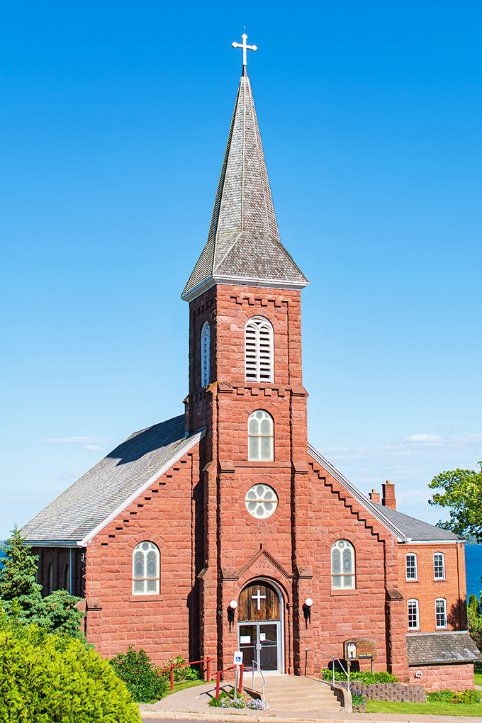 Holy Family Catholic Church's distinctive red sandstone and soaring steeple have guided generations of sailors and souls back to Bayfield's welcoming shores.