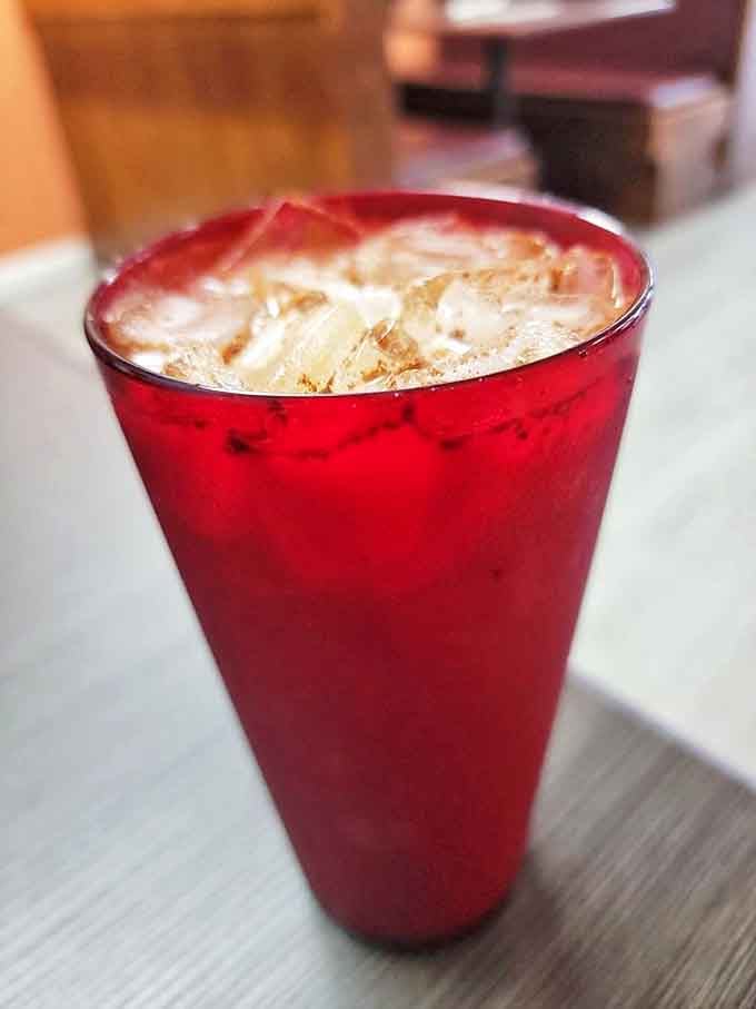 The horchata arrives in a ruby-red glass, promising cinnamon-kissed refreshment that's like dessert in liquid form.