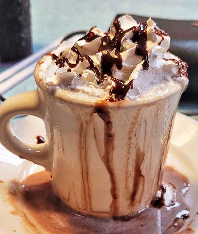 Hot chocolate that looks like it's auditioning for a Hallmark Christmas movie &ndash; complete with whipped cream mountain and chocolate avalanche.
